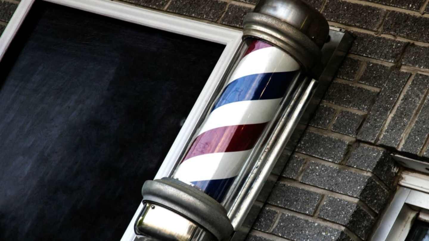 Why are the colors red, white, and blue used on barber poles?